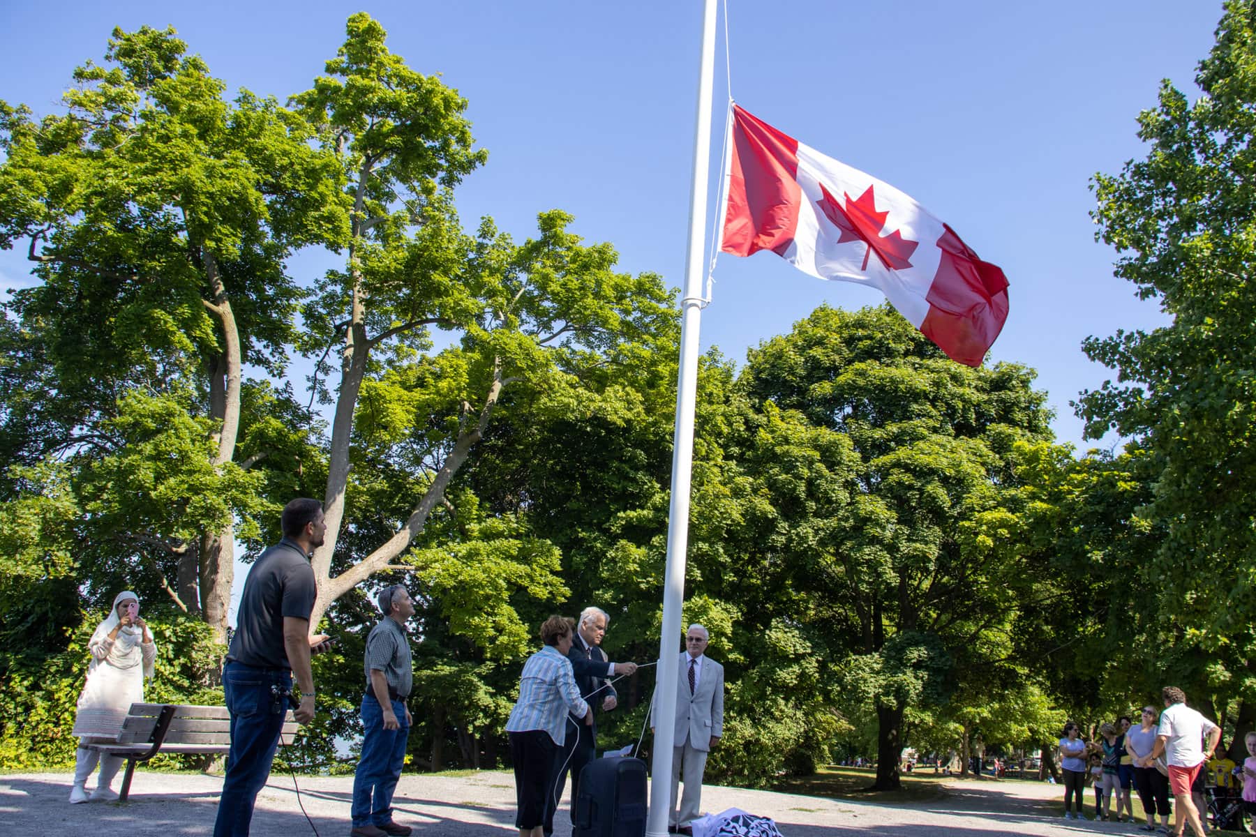 Small crowd gathers to watch first flag raising at Queen's Royal Park